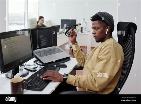 Young Contemporary African American It Engineer Decoding Data By Workplace In Openspace Office