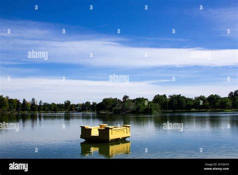 A Floating Yellow Sculpture Structure Floating On A Pond At Denver