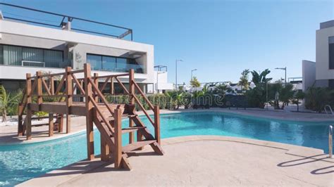 Luxury Resort Pool With Wooden Bridge And Modern Apartments Stock Video