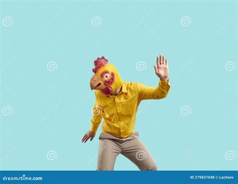 Happy Guy Wearing Funny Yellow Chicken Mask Dancing And Having Fun At