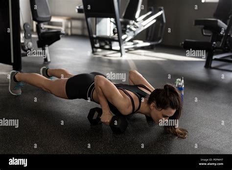 Woman Doing Push Ups On Dumbbells In Fitness Studio Stock Photo Alamy