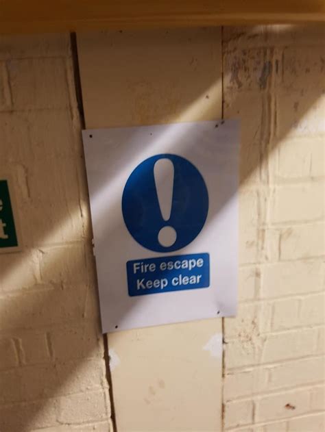 When One Health And Safety Solution Creates Another Problem The Fire Escape Sign Is Nailed