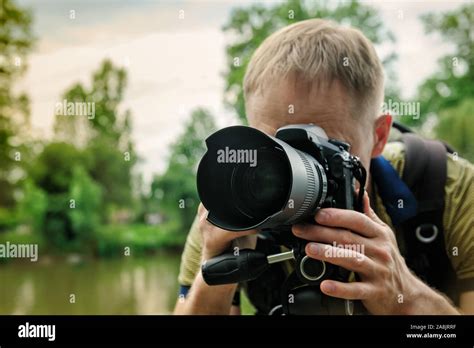 The Photographer Is Photographing With A Tripod He Is Focusing On The