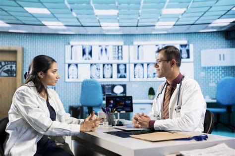 Indian General Practitioner And Patient Engage In A Medical