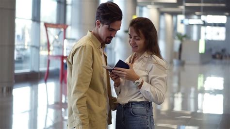 Free Stock Video Excited Woman Showing Passport With Visa Stamp To Her Babefriend At The Airport