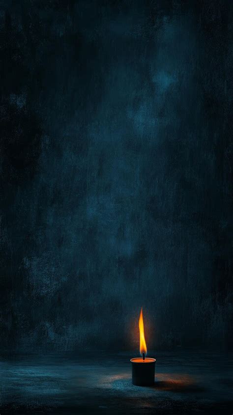 solitary candle flame illuminating dark room with soft glow and