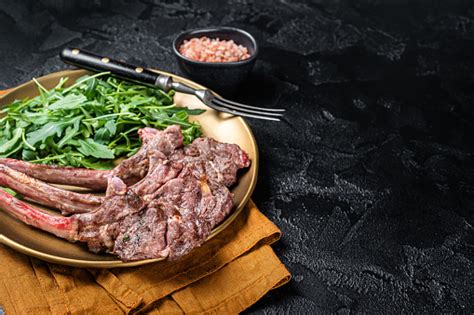 Bbq 구운 양고기 커틀릿 또는 양고기 찹 스테이크와 Arugula 샐러드를 접시에 곁들입니다 검은 배경 상단 보기 공간 복사 갈비 음식에 대한 스톡 사진 및 기타 이미지