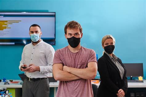A Group Of Colleagues Working Together In A Robotics Laboratory Focusing On The Intricate