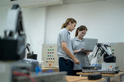 Trainee Robotics Engineer Learning With Programming And Manipulating Robot Hand Industrial