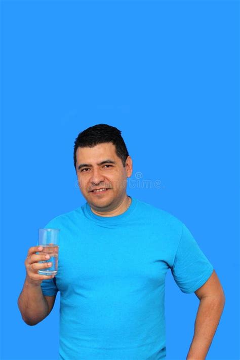 Dark Skinned Latino Adult Man Shows His Glass With Water To Hydrate Himself In Hot Weather Stock