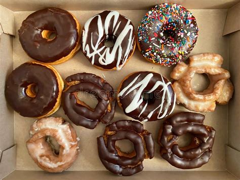 Assortment Of Ten Donuts In A Box For Breakfast In The Morning Stock