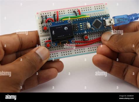 Inventor Displaying His Small Graphic Game Controlled By A Set Of
