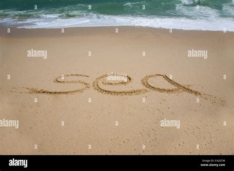 Sea Written In Sand Stock Photo Alamy