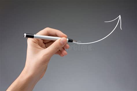 hand drawing curved white line on clear surface with pen stock