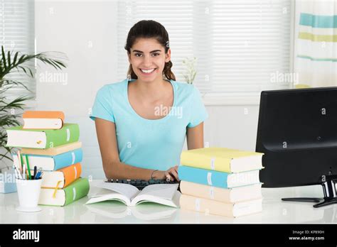 Female Babe Using Computer While Studying At Table Stock Photo Alamy