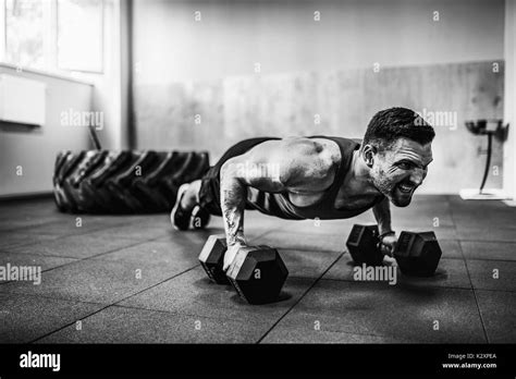 Muscular Man Doing Pushup Exercise With Dumbbell Stock Photo Alamy
