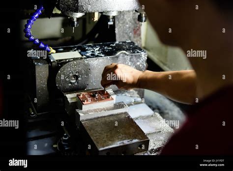 Worker Is Setting Up A CNC Milling Machine Stock Photo Alamy