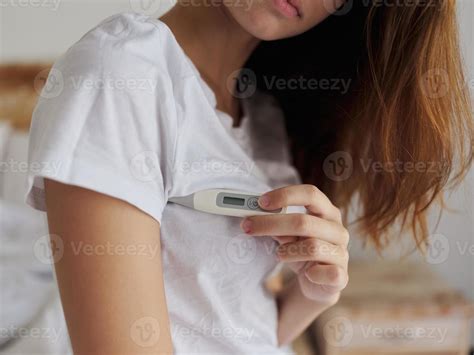 Woman Holding Thermometer Under Armpit Checking Temperature 22332190 Stock Photo At Vecteezy