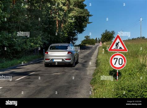 Roadworks Signs On A Country Road And Blue Sky Summer Morning On A