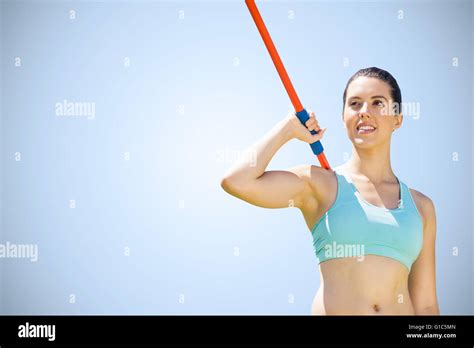Composite Image Of Woman Sporty Posing With Her Javelin Stock Photo Alamy