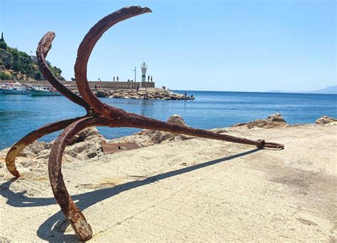 Old Rusty Anchor On The Seashore At The Port With Ships And Yachts There Is An Anchor