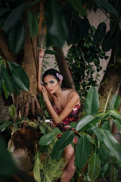 Premium Photo A Young Beautiful Brunette Posing Among Dense Thickets