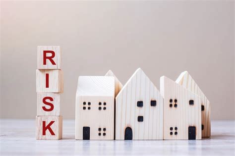 Premium Photo Risk Cube Blocks With Wooden House Model On Table Background