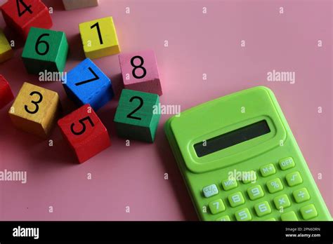 Calculator And A Wooden Cubes With Mathematical Symbol Education And