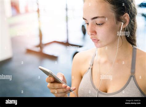 Young Fitness Girl Checking Her Performance On Smatphone After Hard