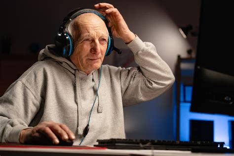 Senior Male Gamer Streamer Scratch Head Showing Confused Expression When Playing Computer Game