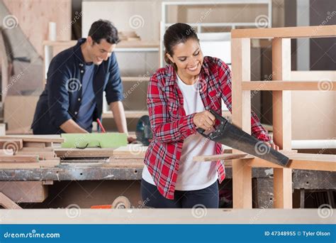 Carpenter Cutting Wood With Handsaw In Workshop Stock Image Image Of