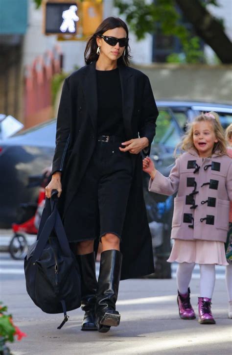 Irina Shayk In A Black Trench Coat Enjoying A Walk With Her Daughter In