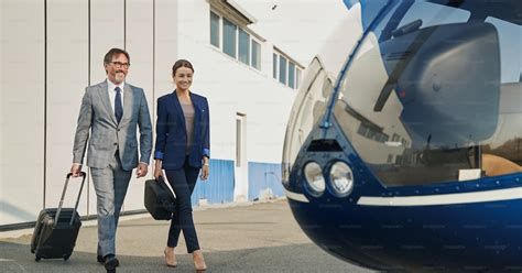 트롤리 여행 가방을 든 쾌활한 사업가와 헬기에 접근하는 가방을 든 웃는 사업가 사진 Unsplash의 수송 이미지