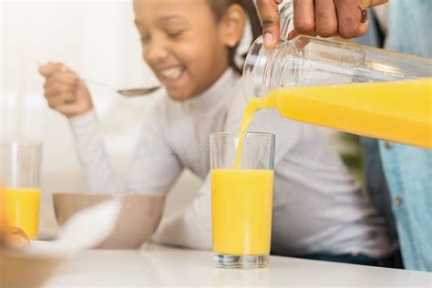 Father Pouring Orange Juice into a Glass Stock Image - Image of ...