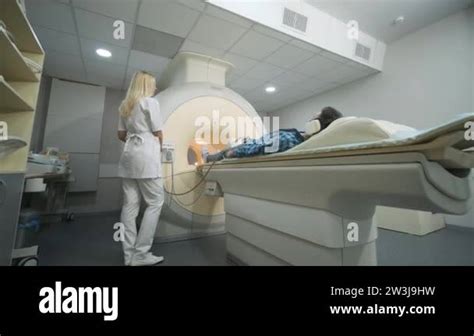 Woman Doctor Makes Knee Joint Mri Scanning Young Man Patient On
