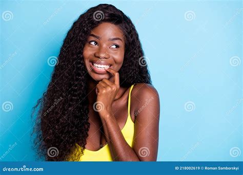 Portrait Of Attractive Cheerful Wavy Haired Girl Biting Nail Thinking
