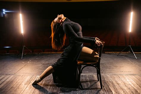 Young Woman Performing Interpretative Dance In An Empty Theatre Stock