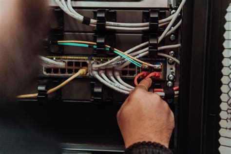 Premium Photo Close Up Of Technician Setting Up Network In Server Room