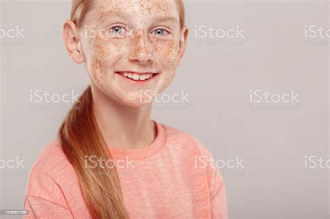 Inclusive Beauty Girl With Freckles Standing Isolated On Grey Smilign