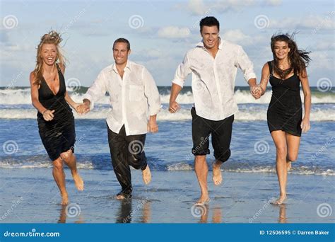 Two Couples Having Fun Running At The Beach Stock Image Image Of