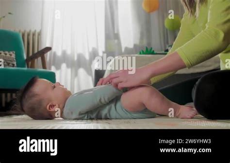 Mother Lifting Baby Boy Helping Him To Sit Mom Playing With Baby Learning It To Sit Down Stock