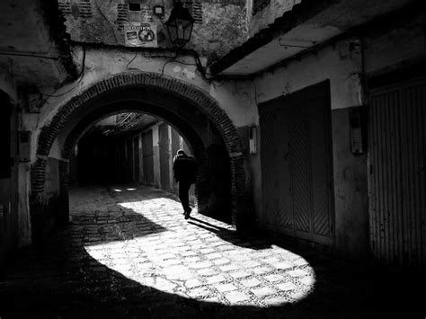Premium Photo Rear View Of Man Walking On Street Amidst Buildings