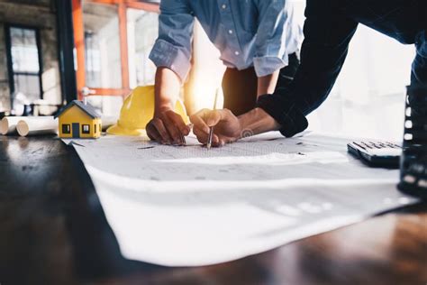 Architecture Or Civil Engineer Team Analyze With Construction Blueprint Plan Engineer