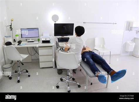 Ultrasonic Examination Of Internal Organs A Man On An Abdominal Ultrasound Scan Apparatus For