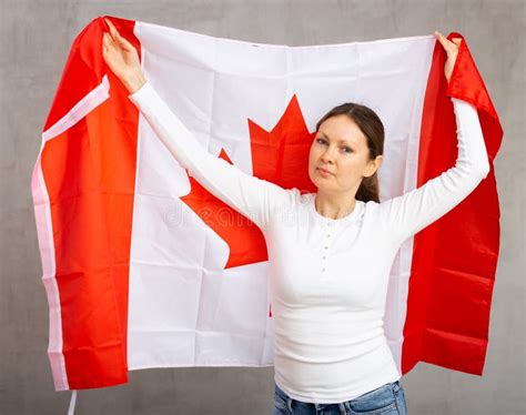 Joyful Female Fan Of Favorite Team Of Canada With The National Flag In