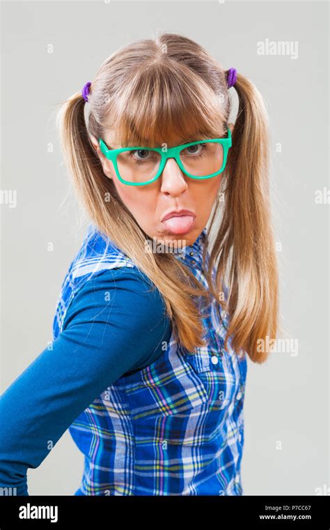 Studio Shot Portrait Of Nerdy Woman Who Is Making Funny Face Stock