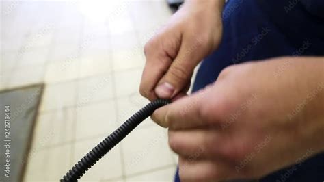 Camera Shows Male Worker S Hands Are Professionally And Actively Putting Thin Black Wire Into