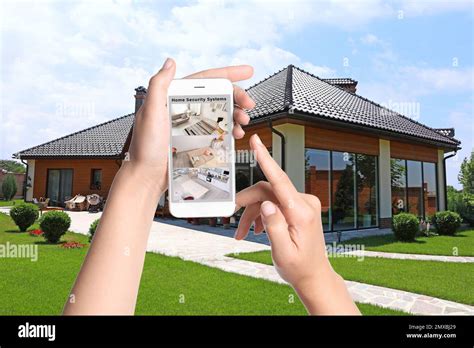 Alarm System Woman Monitoring Modern CCTV Cameras On Smartphone Near Her House Closeup Stock