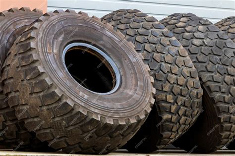 Old Used Truck Tires Stacked On Side Falling Over Premium Photo