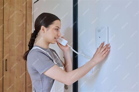 Premium Photo Teenage Girl Holding Intercom Handset While Talking To